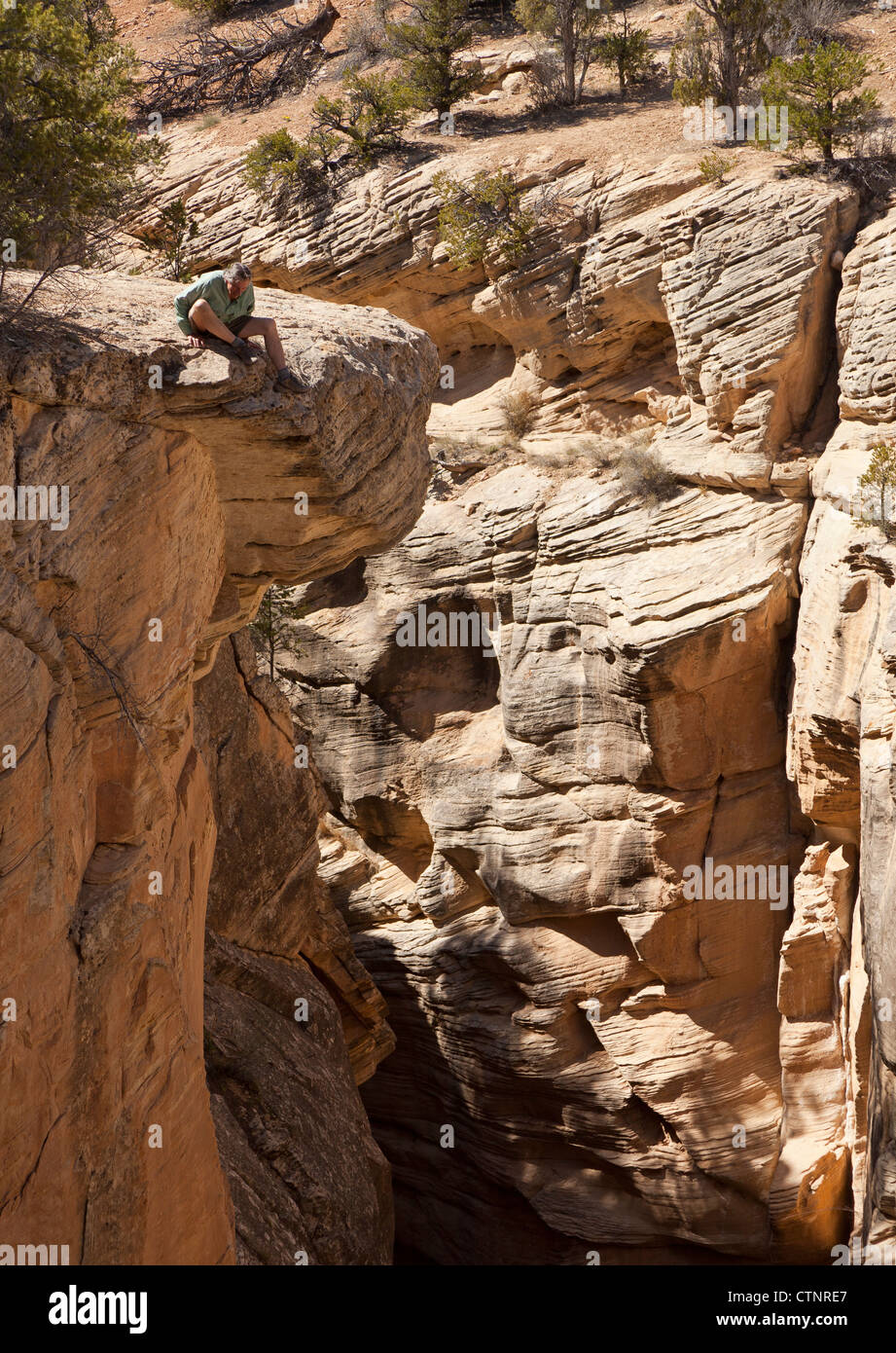 A man on the edge of a gorge in southern Utah USA Stock Photo - Alamy
