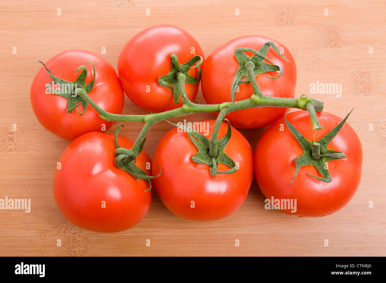 Fresh red tomatoes on the wooden table Stock Photo - Alamy