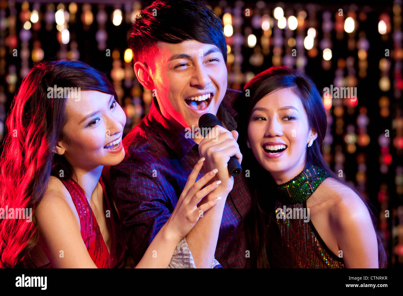 Young people singing Karaoke Stock Photo - Alamy