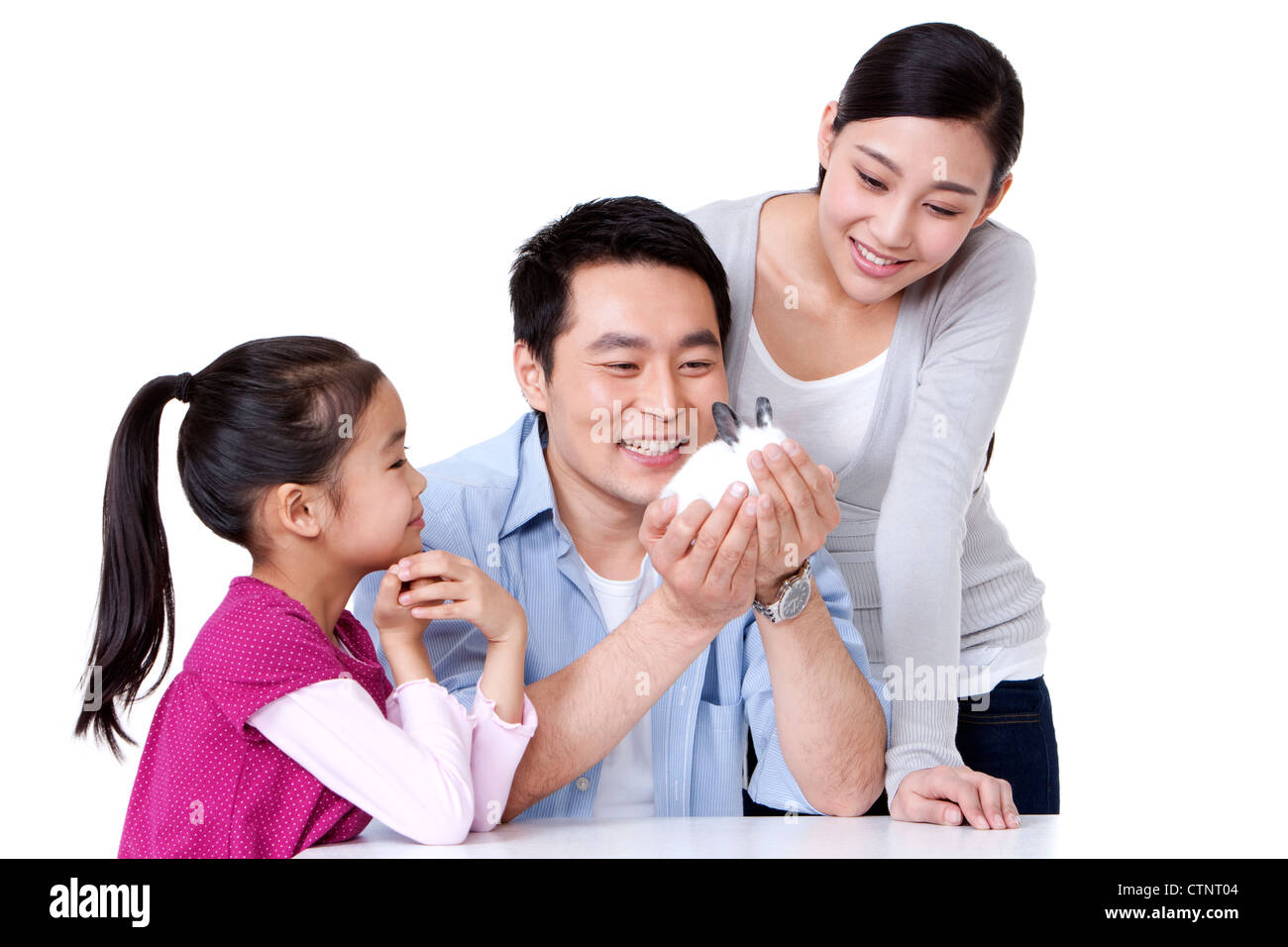 Happy family with pet rabbit Stock Photo - Alamy