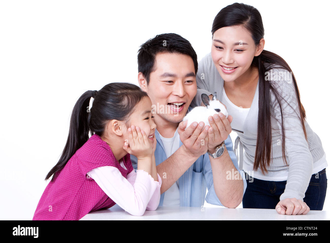 Happy family with a pet rabbit Stock Photo - Alamy