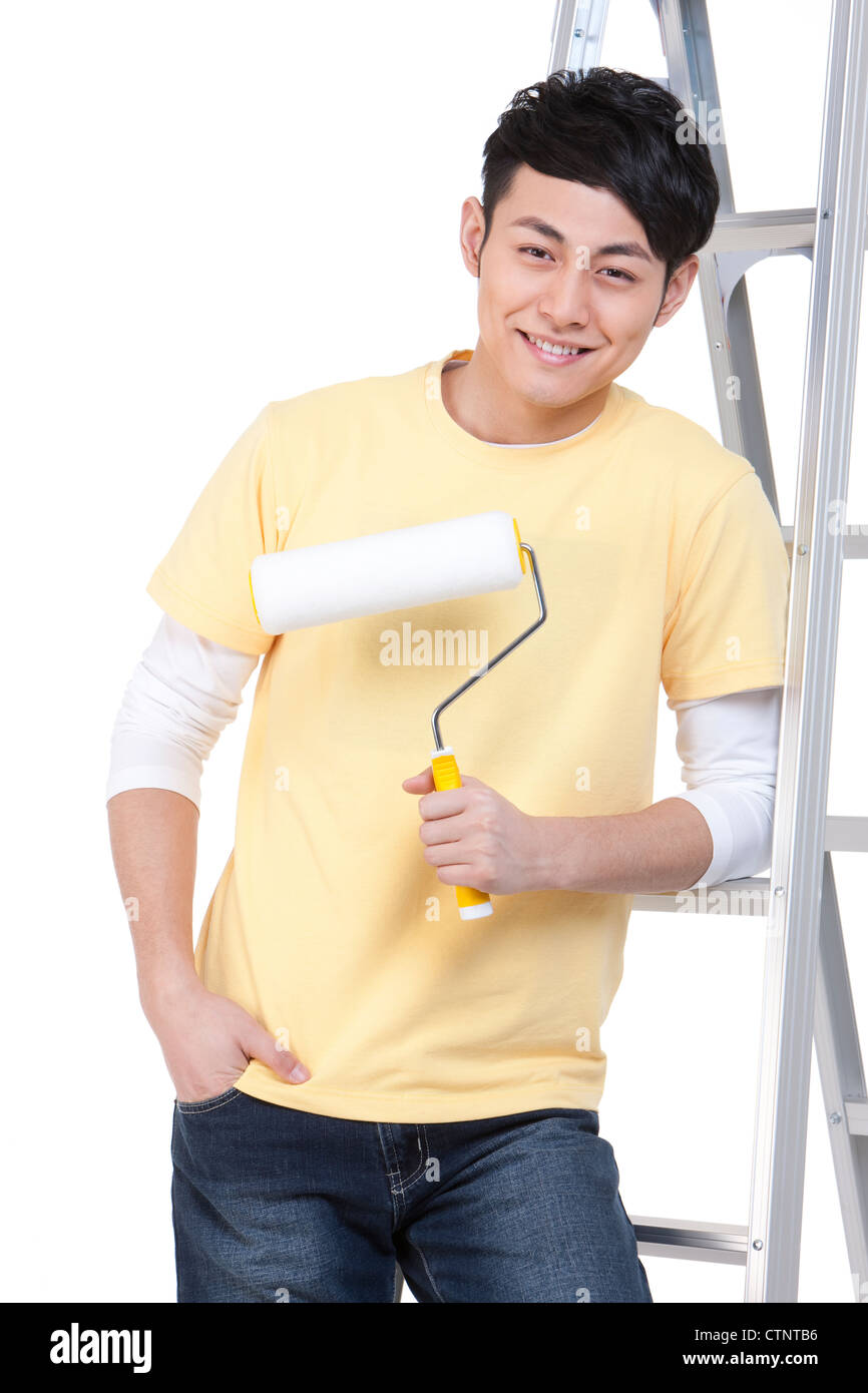 Young man with a Paint Roller Stock Photo - Alamy