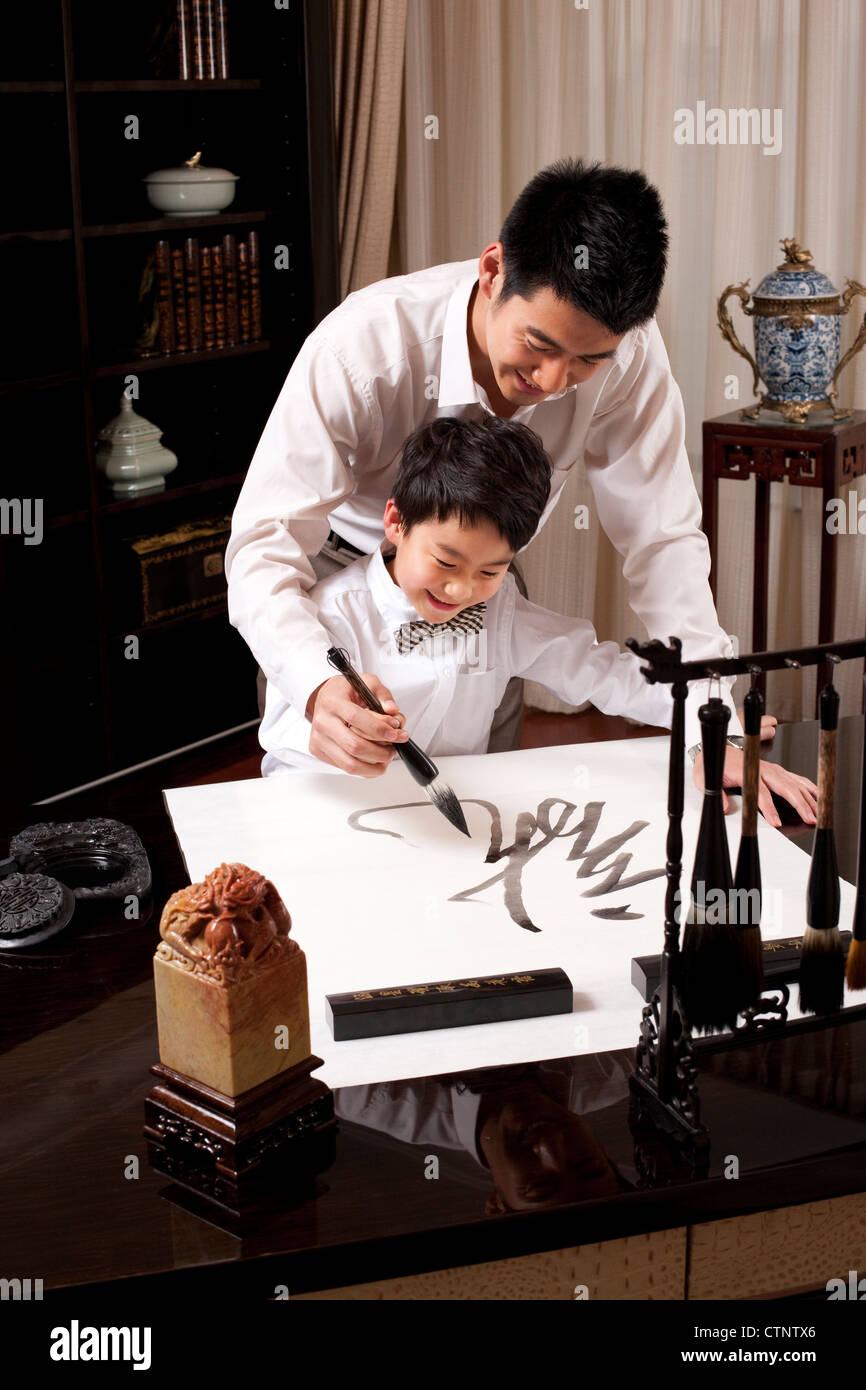 Father and son practising Chinese calligraphy Stock Photo - Alamy