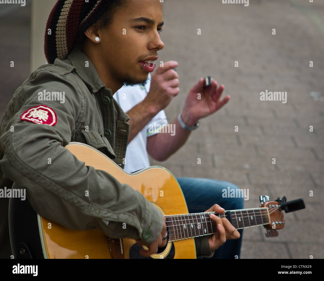 Two buskers in a city street Stock Photo - Alamy