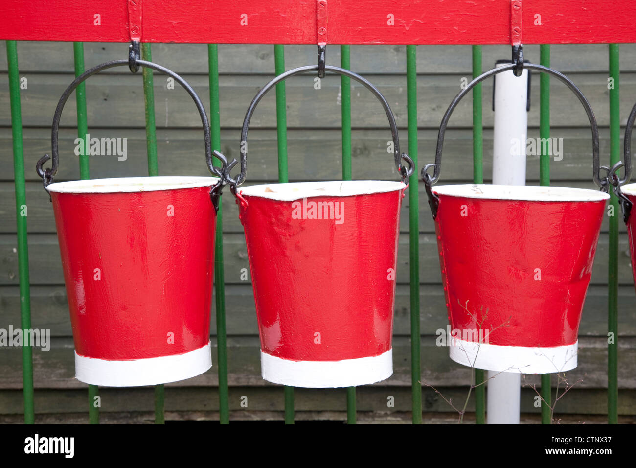 Closeup of Three Red Hanging Buckets Stock Photo - Alamy