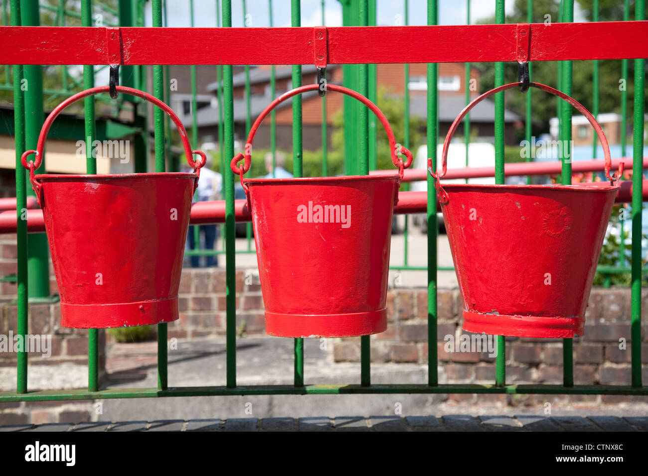 Three Red Buckets at Railway Station Stock Photo - Alamy