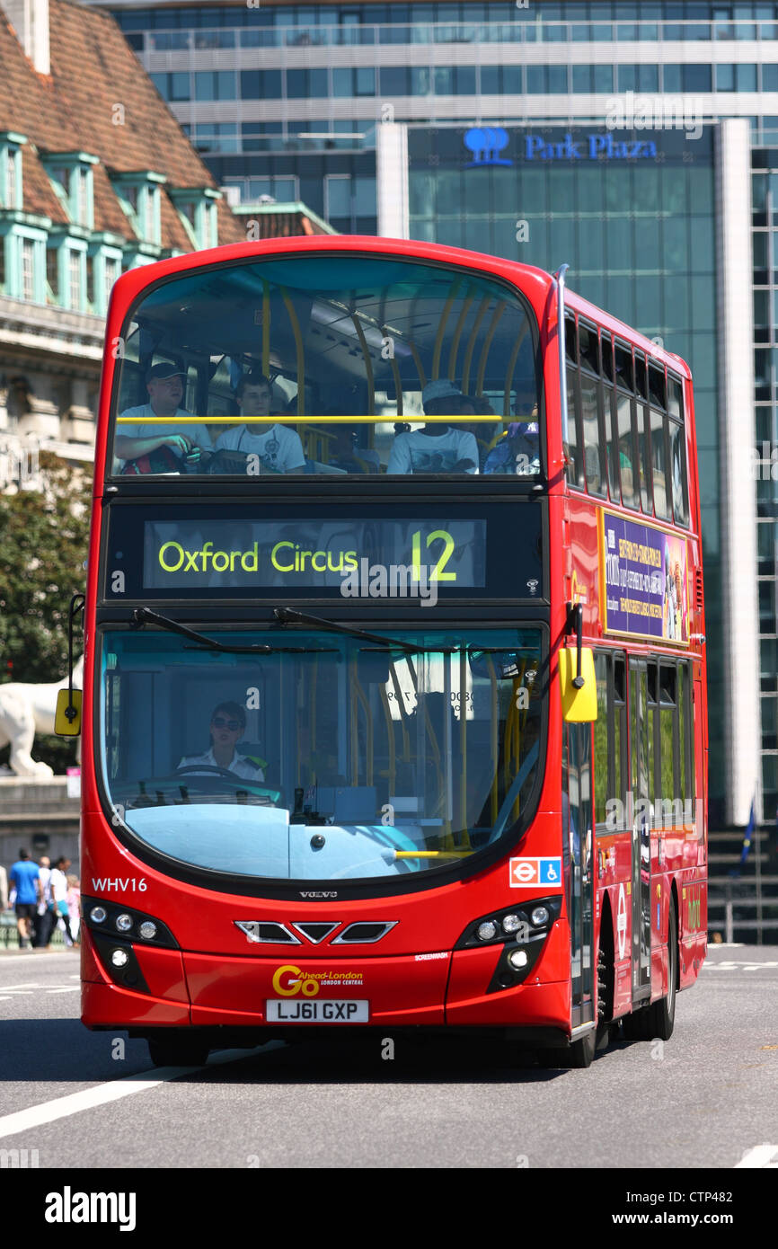 a double decker red London bus traveling on a road in London Stock ...
