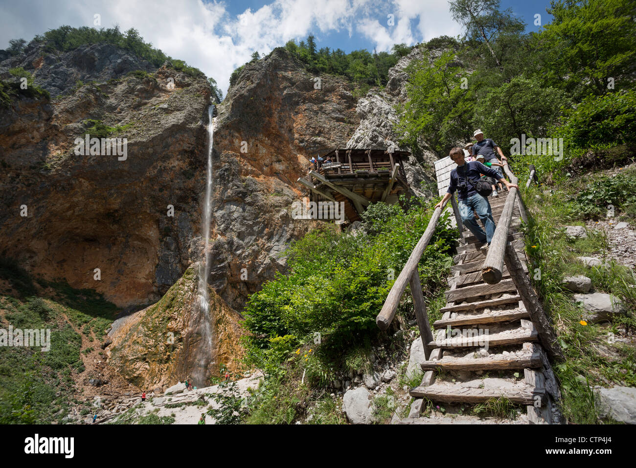 Hikers descend from the "Eagle's Nest" cafe by the Rinka waterfall of ...