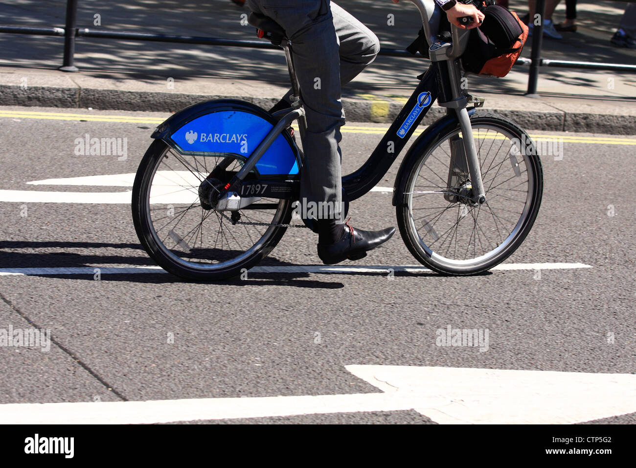 a Boris bike being ridden along a road in London Stock Photo - Alamy