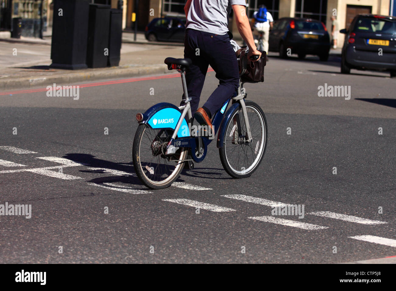 a Boris bike being ridden along a road in London Stock Photo - Alamy