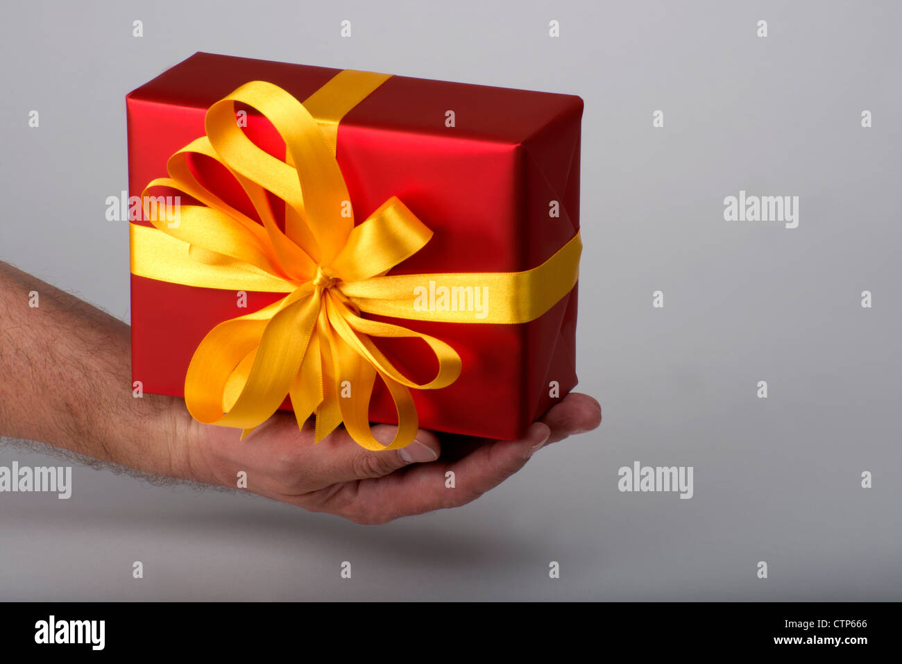 packed gift with red paper Stock Photo - Alamy