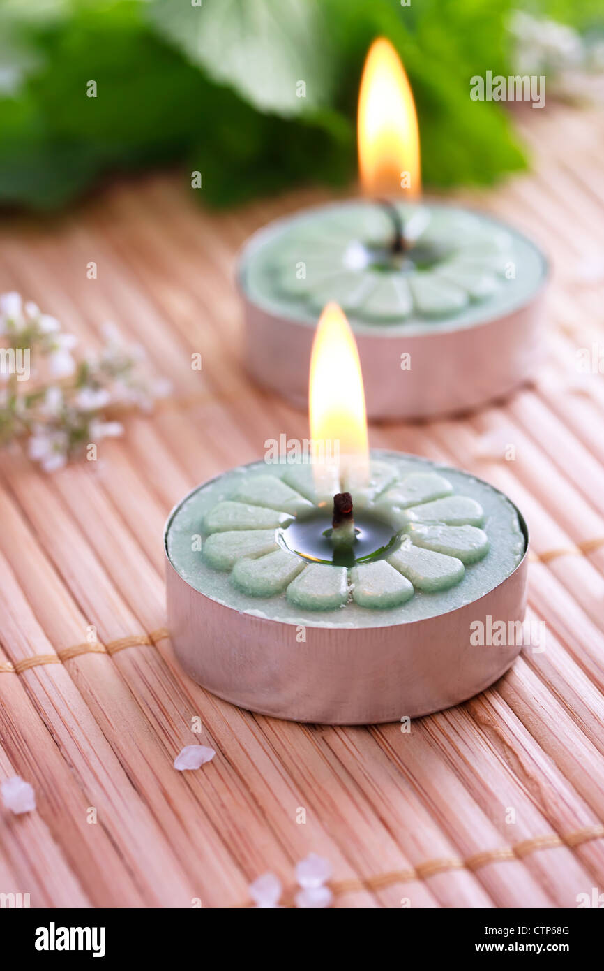 Spa Candles with small flowers and mints Stock Photo - Alamy
