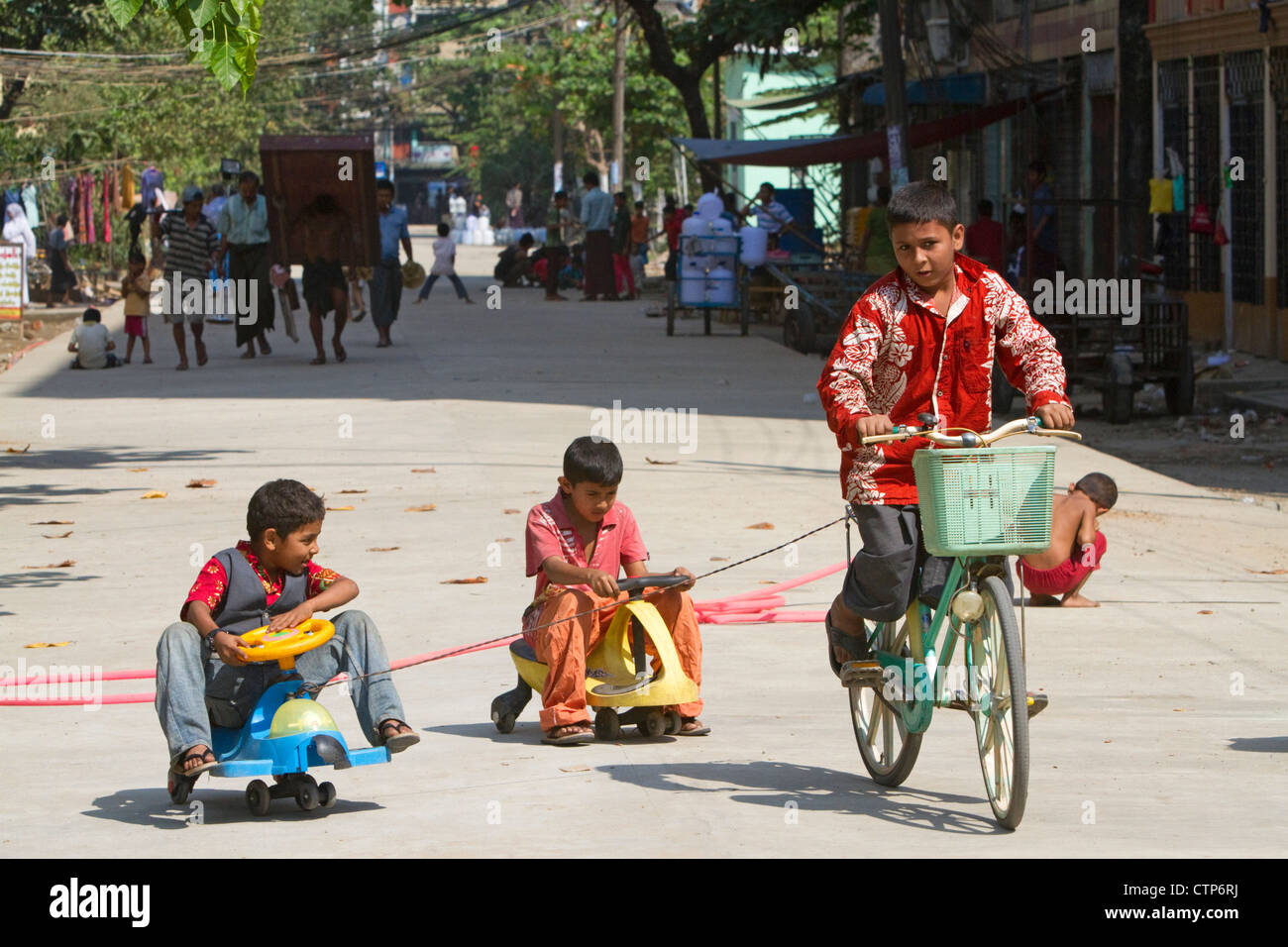 Children riding bicycles on the street in (Rangoon) Yangon, (Burma ...