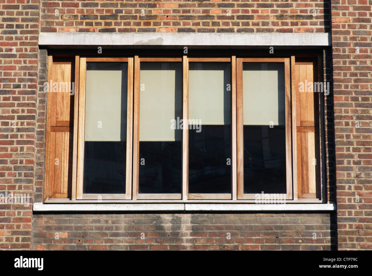 New window fitting with blinds on an old office building, City of ...