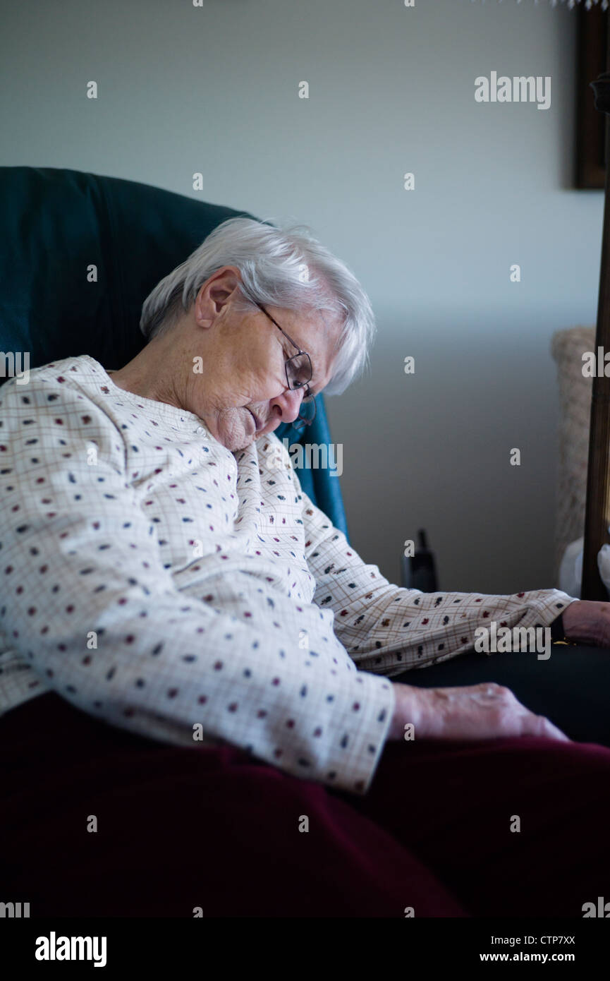 Old woman slumped over asleep in chair Stock Photo - Alamy