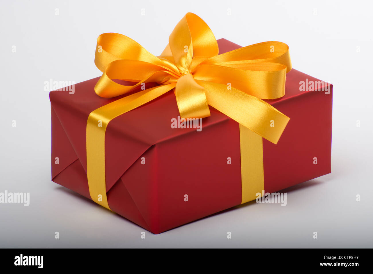 packed gift with red paper Stock Photo - Alamy