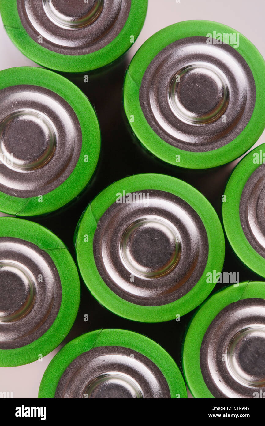 close up the top of AA battery,color on green Stock Photo - Alamy