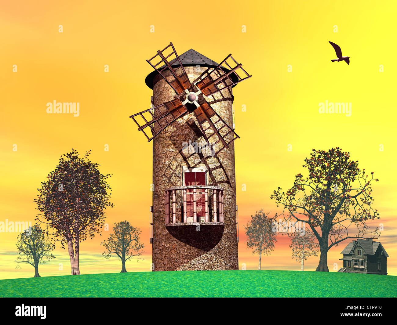 Old windmill in the countryside among trees and next to a small house ...