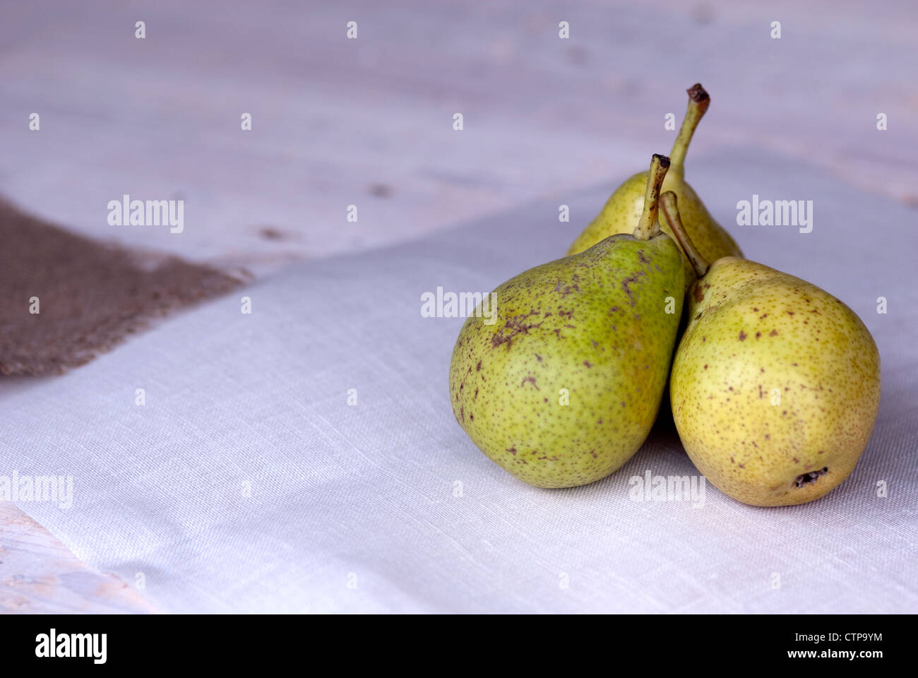 three Guyot pears on a light background with a bright feel Stock Photo ...