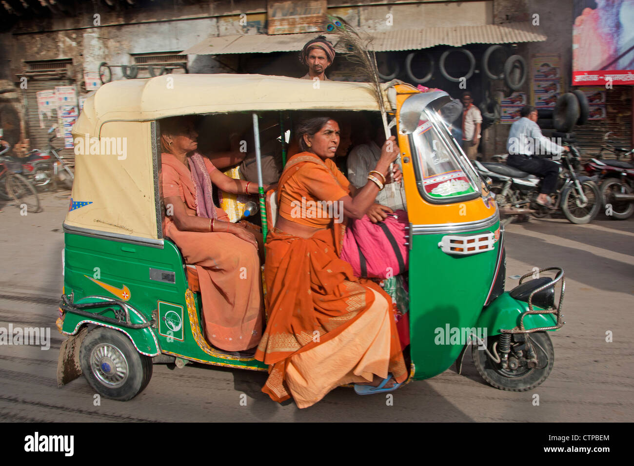 Fully loaded autorickshaw, three-wheeled motorized taxi transporting ...