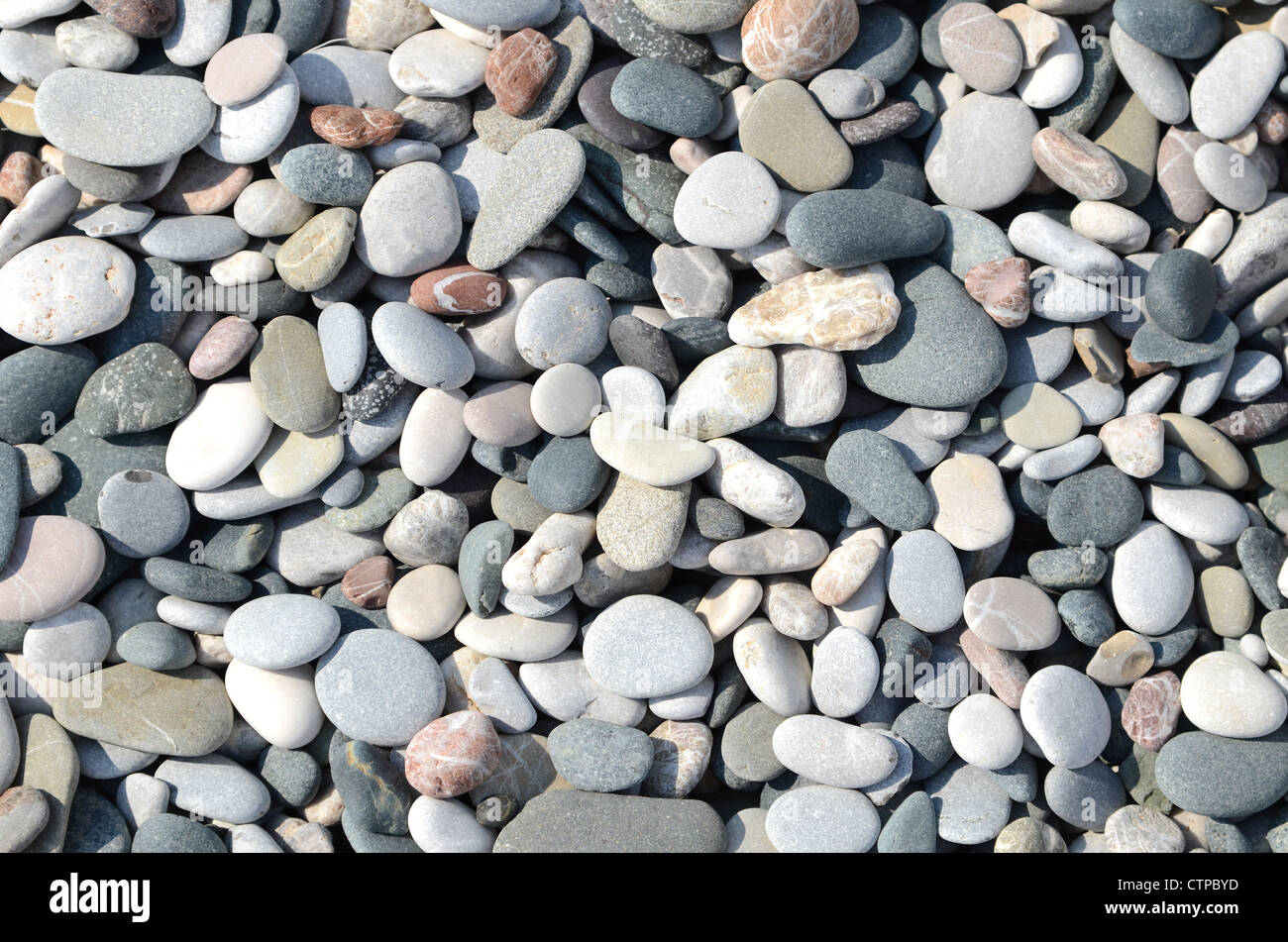 A stone background from a dry river bed Stock Photo - Alamy