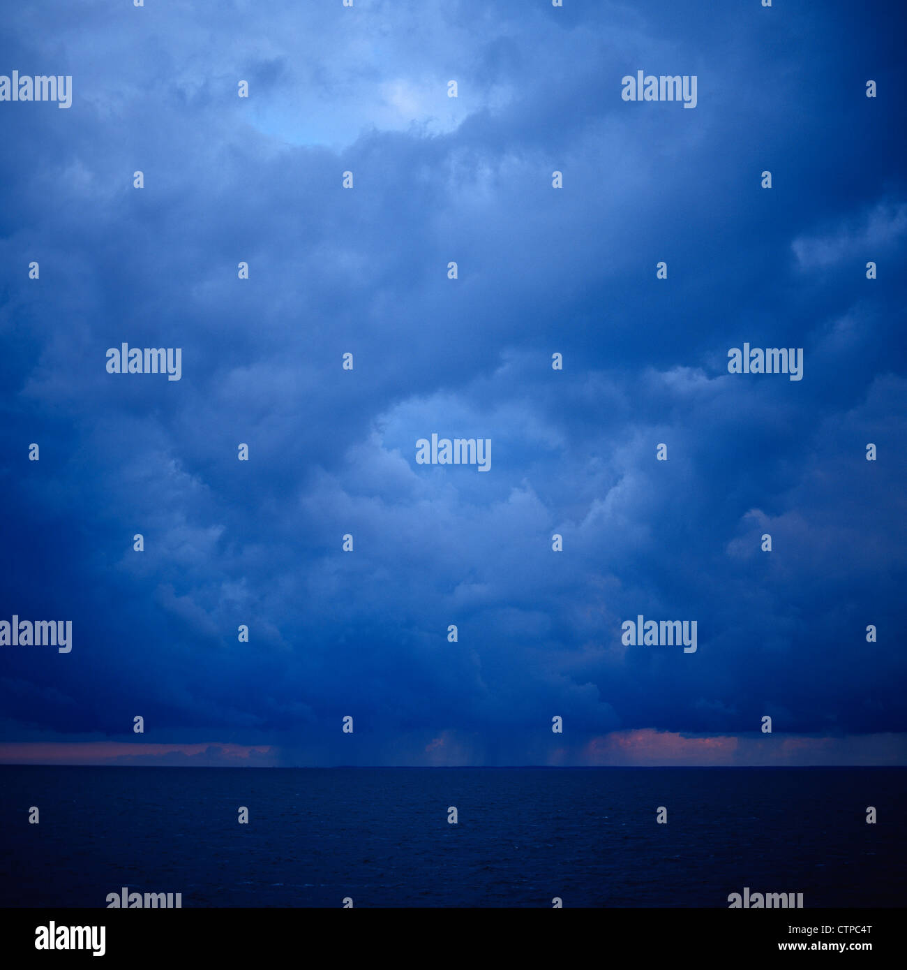 Stormy clouds and rain over a lake Stock Photo - Alamy