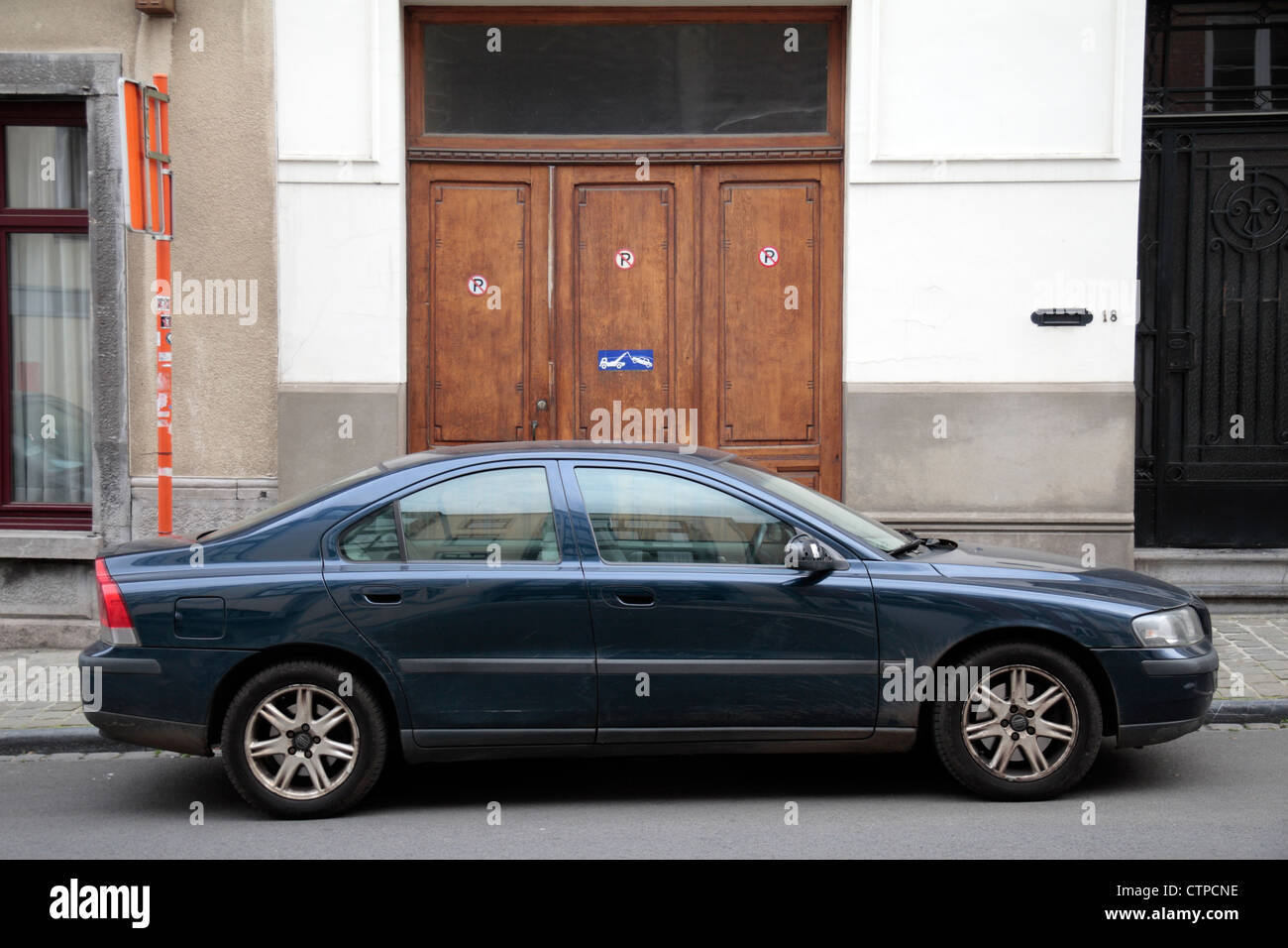 Car blocking an entrance with a sign warning the parked cars will be ...