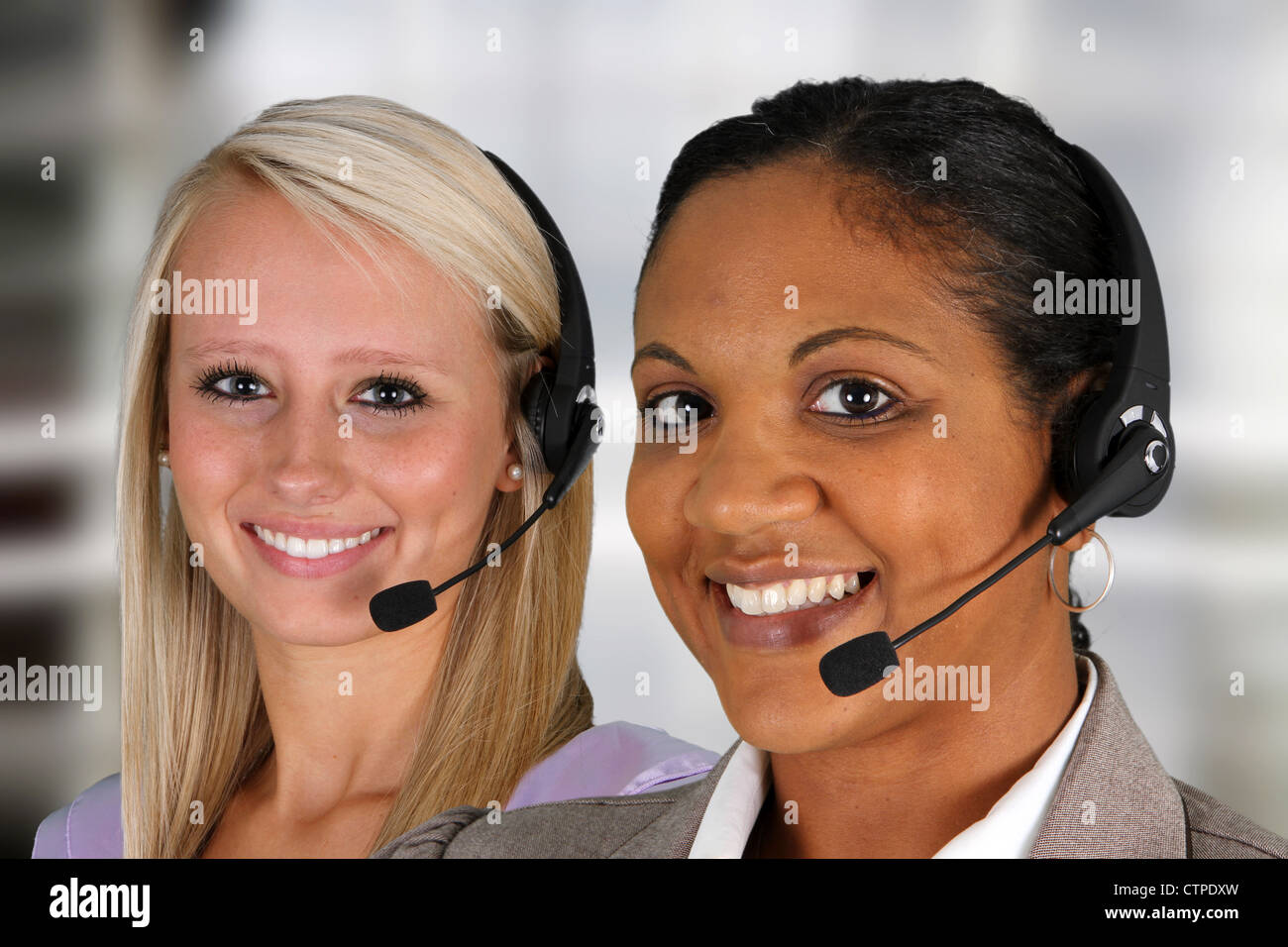 Young women giving help as customer service employees Stock Photo - Alamy