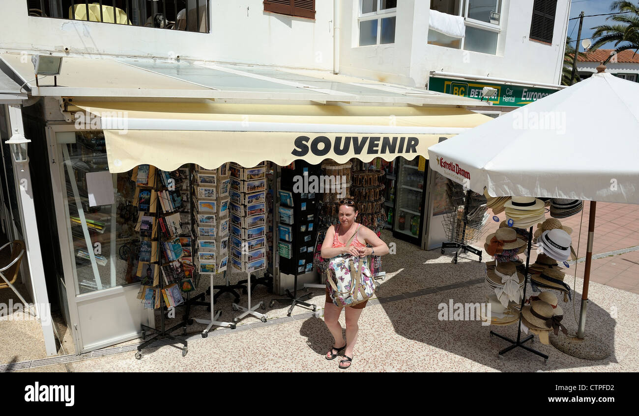 tourist coming out of a holiday souvenir shop in menorca balearic ...