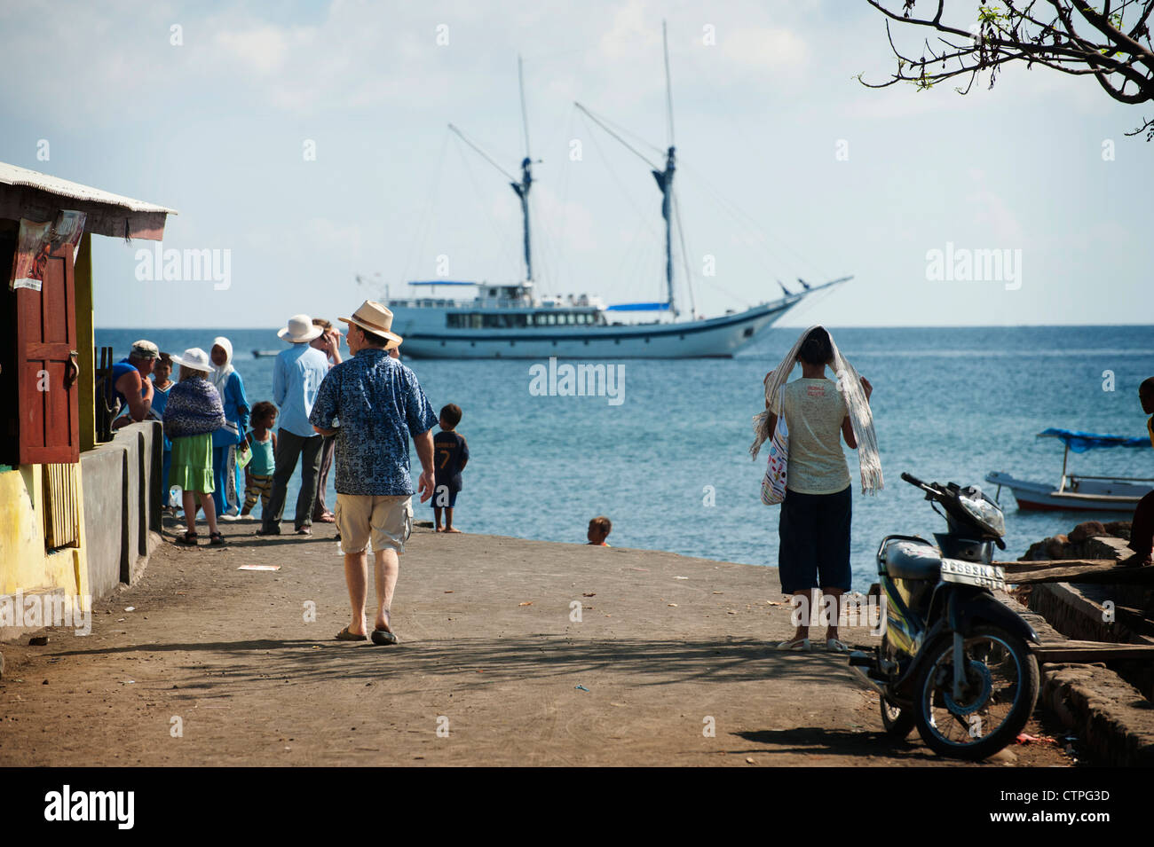 Tourists enter the Muslim village of Komodo on the island of Komodo ...