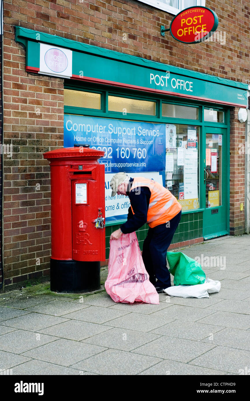 postman emptying post box outside of post office Stock Photo - Alamy