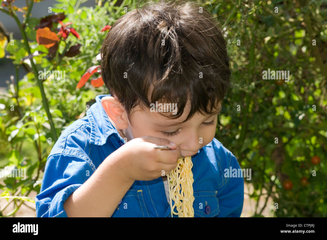 young boy enjoying meal of instant noodles Stock Photo - Alamy