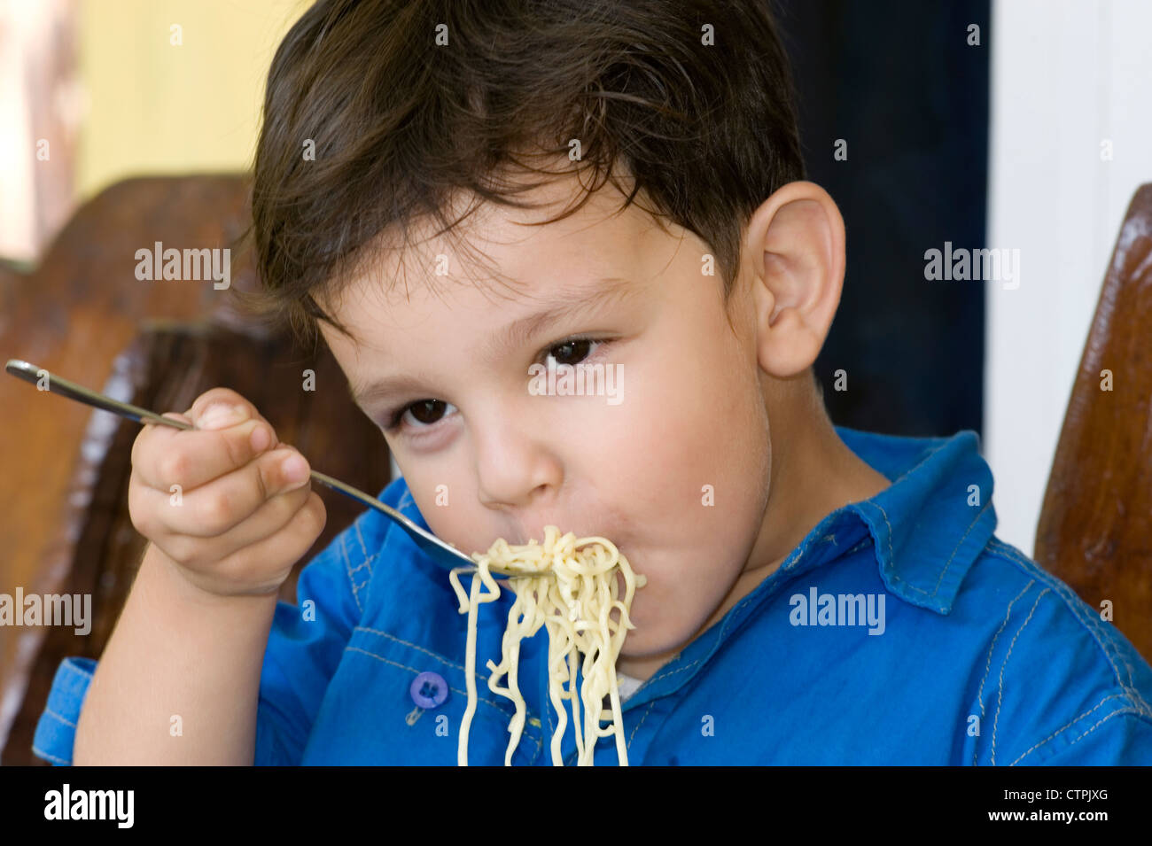 young boy enjoying meal of instant noodles Stock Photo - Alamy