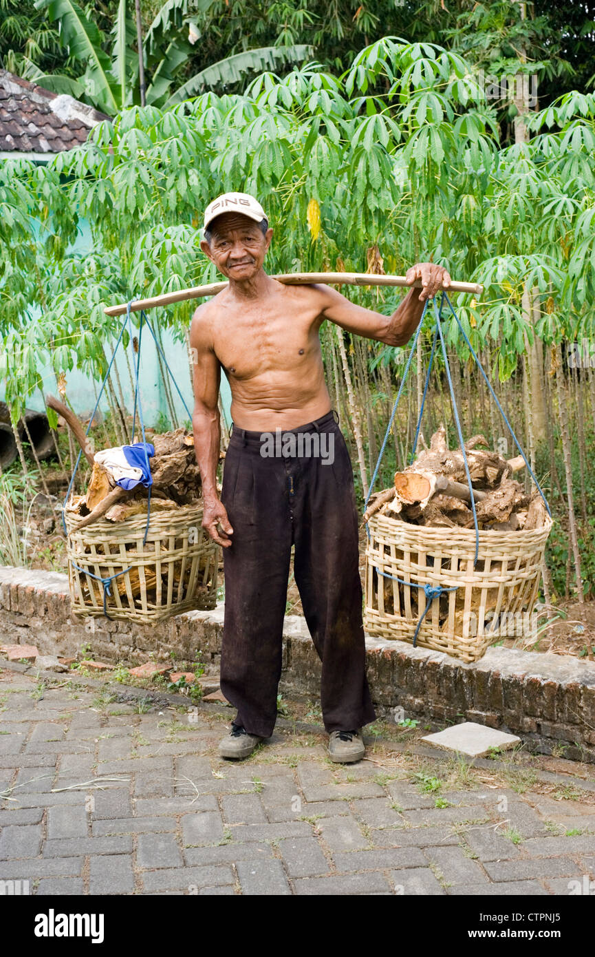 local villager in rural village street with traditional wood filled ...
