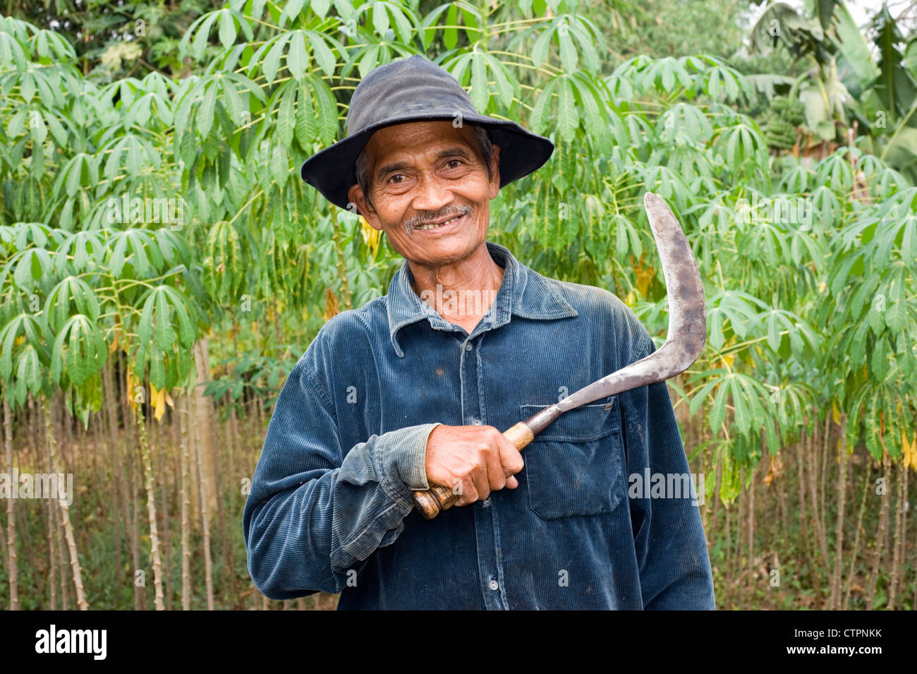 local villager in rural village street with scythe in hand Stock Photo ...