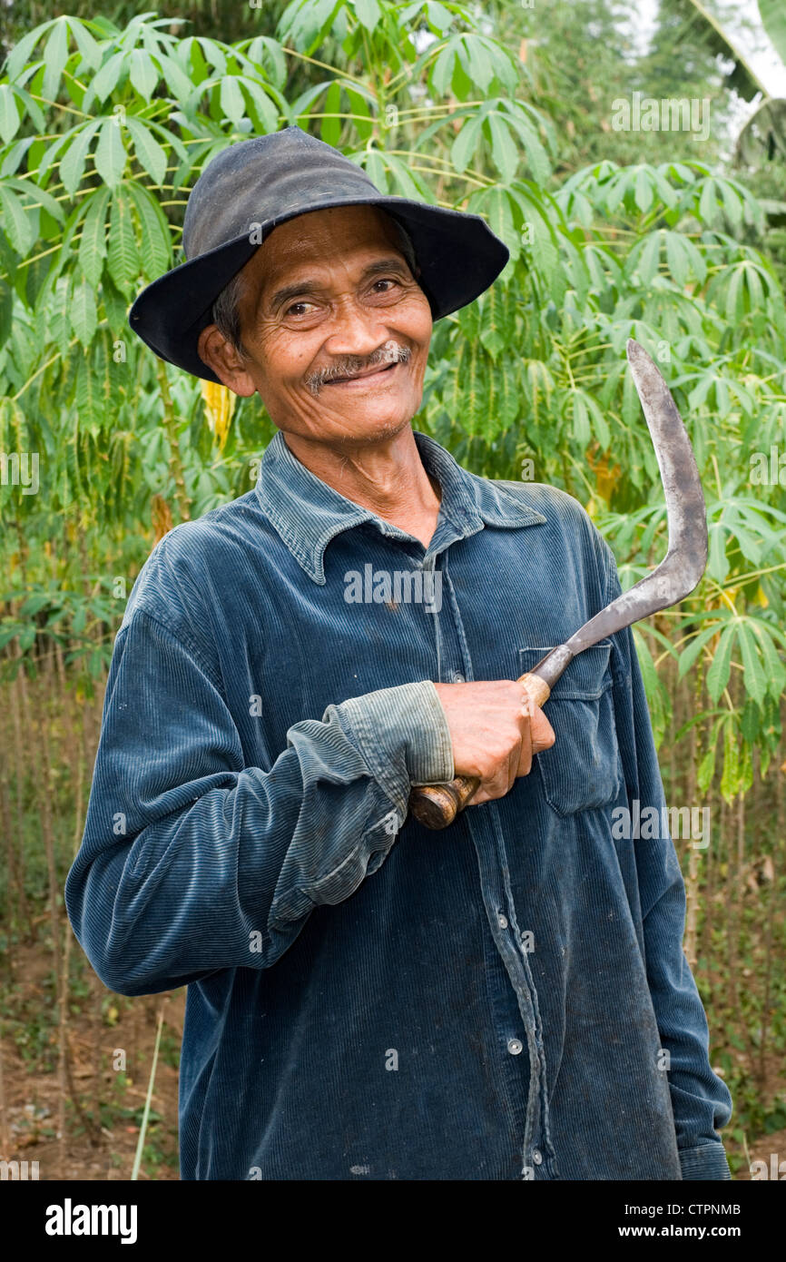 local villager in rural village street with scythe in hand Stock Photo ...