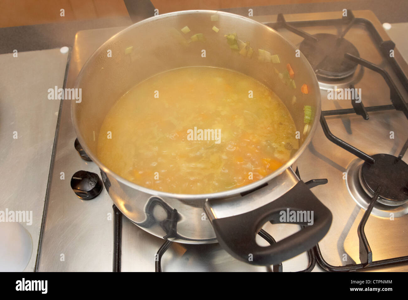 pot of home made soup boiling on a gas ring Stock Photo - Alamy