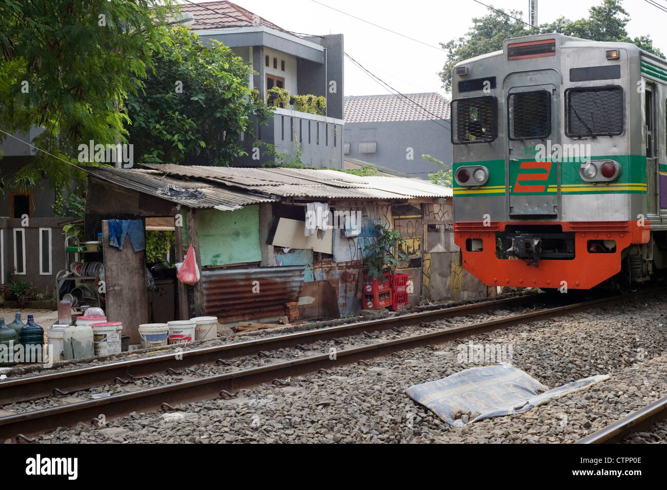 run down shack serving as a home and shop next to busy commuter railway ...