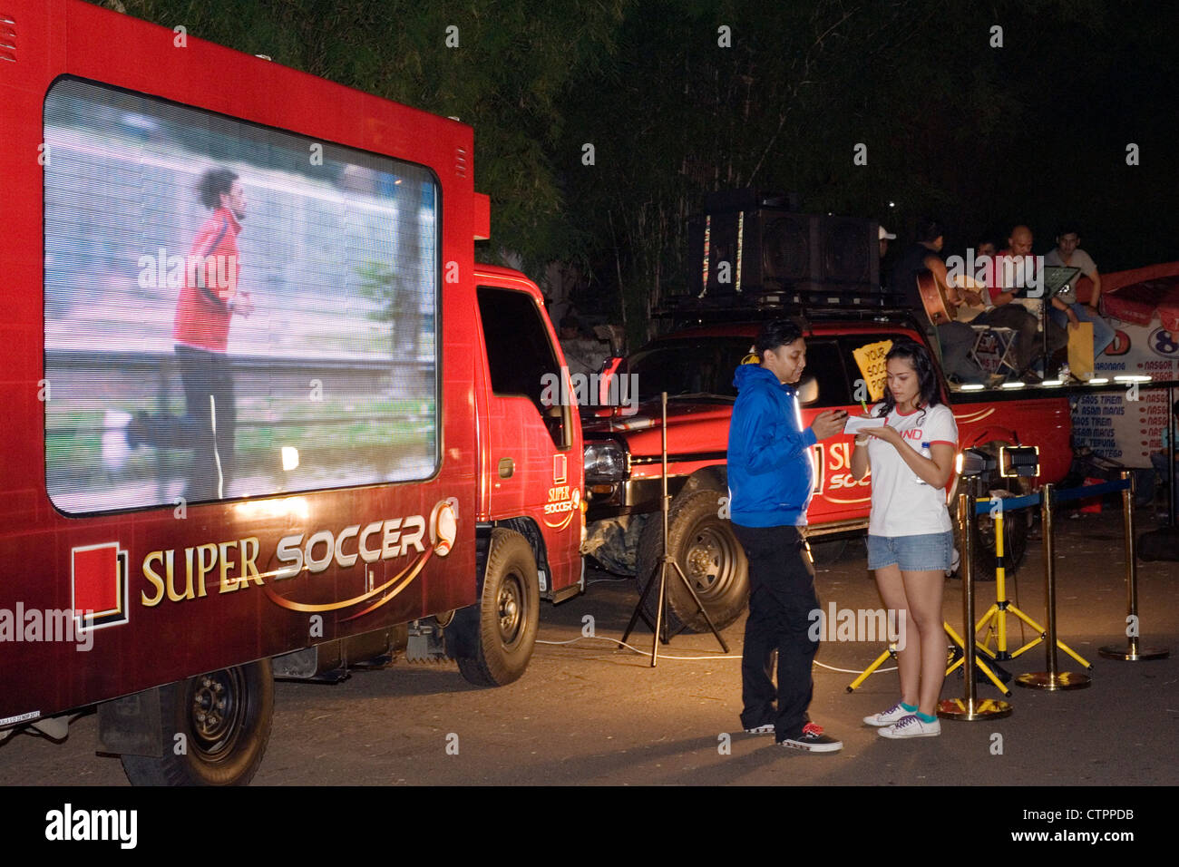 female team member doing a promotion with television and musicians at a ...