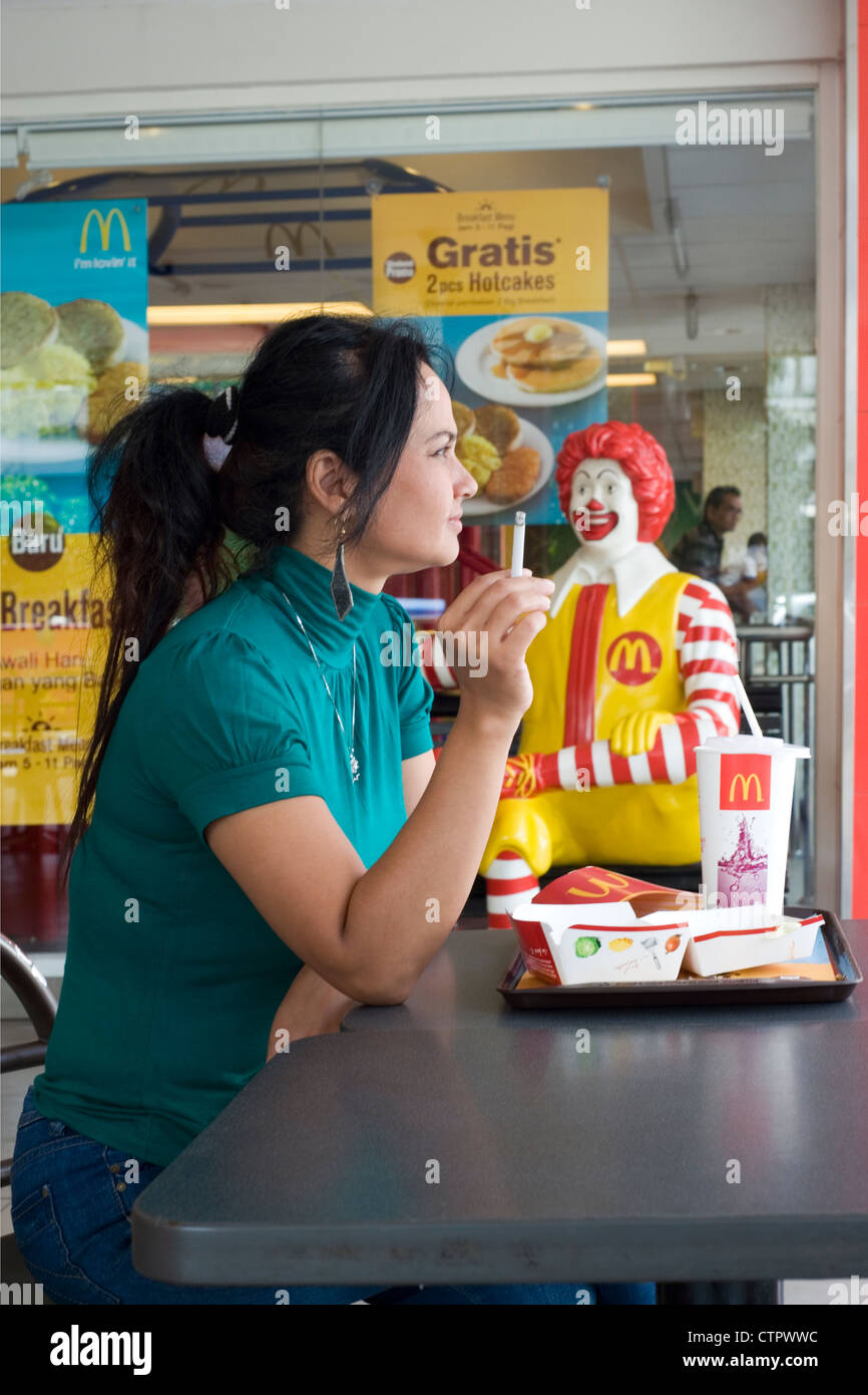 A woman smoking in a restaurant hi-res stock photography and images - Alamy