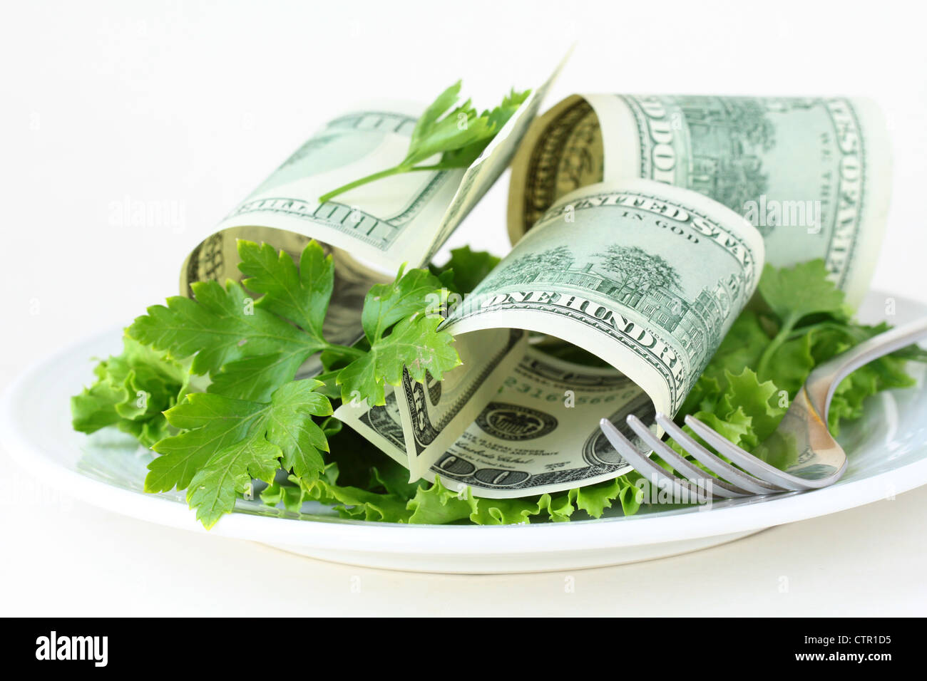 U.S. currency dollars on a plate - salad cash Stock Photo - Alamy