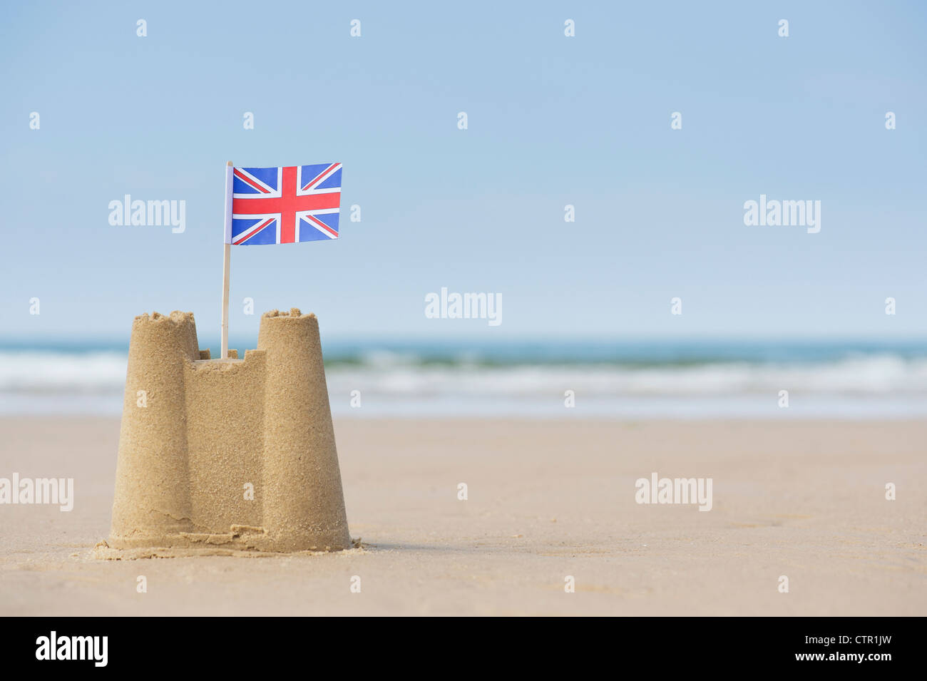 Union Jack flag in a sandcastle on a beach. Wells next the sea. Norfolk ...