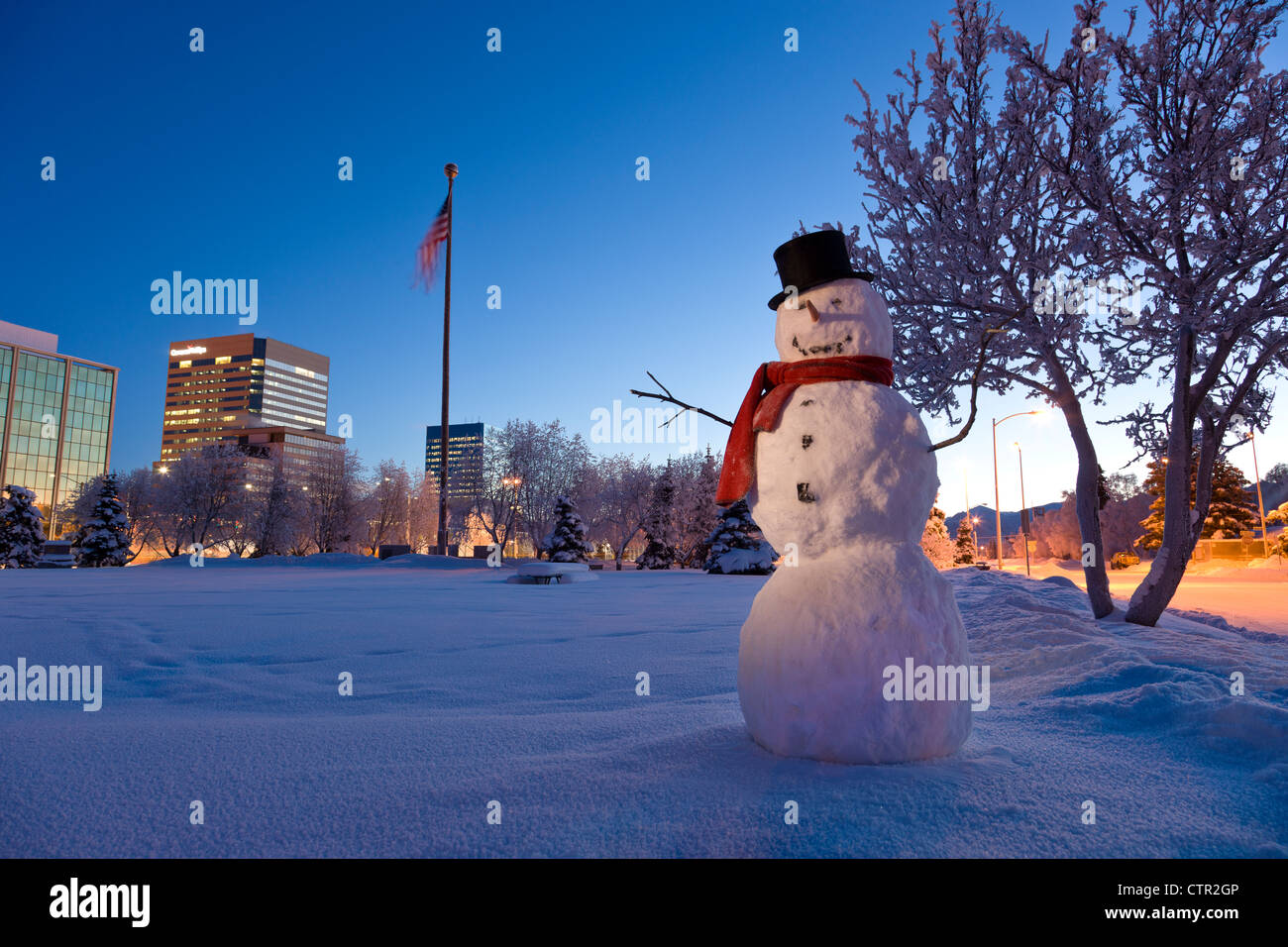 Snowman standing in Delaney Parkstrip downtown Anchorage in background ...