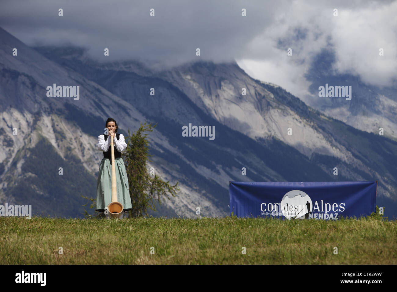 Alphorn players in traditional costume take part in the Cor des Alpes ...