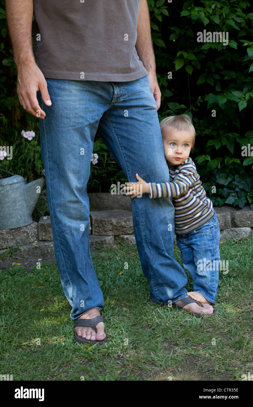 Children hugging fathers leg hi-res stock photography and images - Alamy