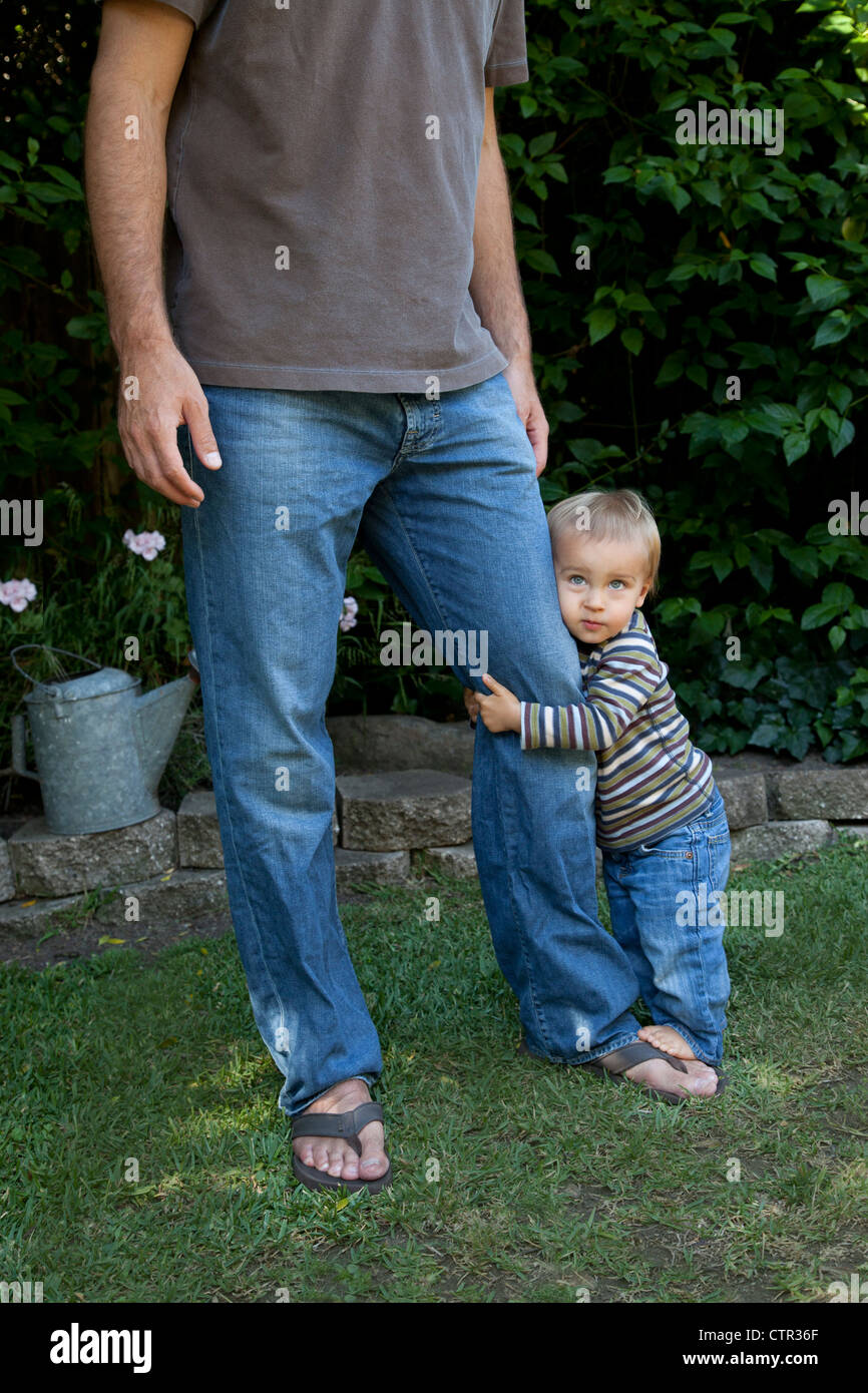 Children hugging fathers leg hi-res stock photography and images - Alamy