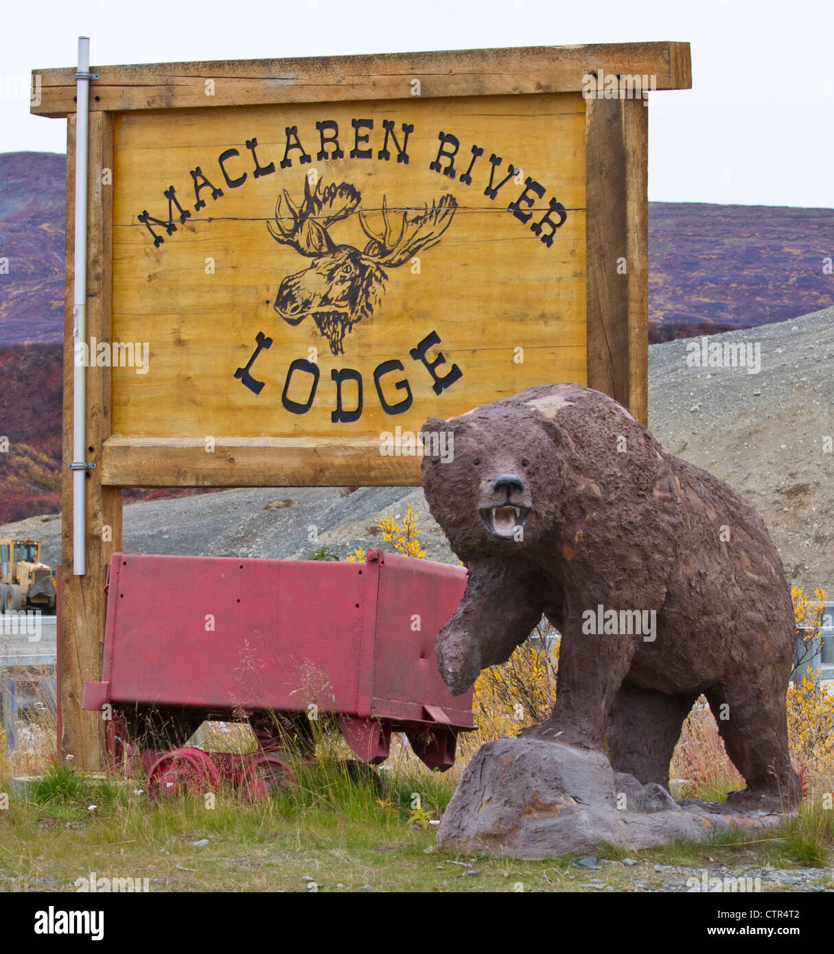 Maclaren River Lodge sign, with mining rail cart and carved brown bear ...
