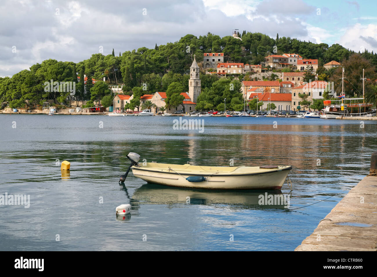 A small boat moored in a scenic medieval fishing village along the ...