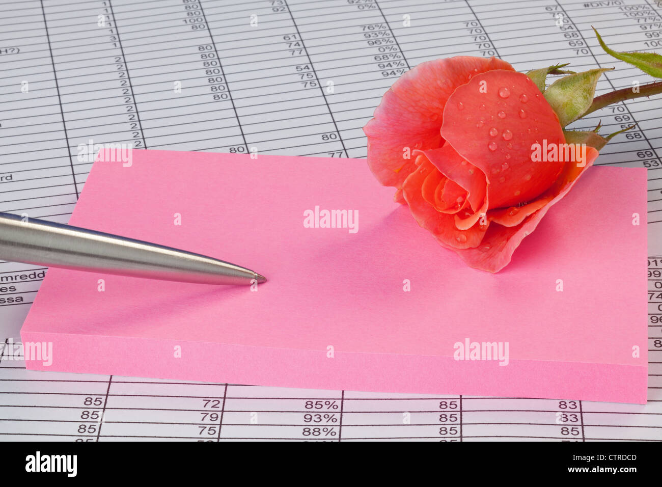 A rose, notepad and pen on a spreadsheet Stock Photo - Alamy