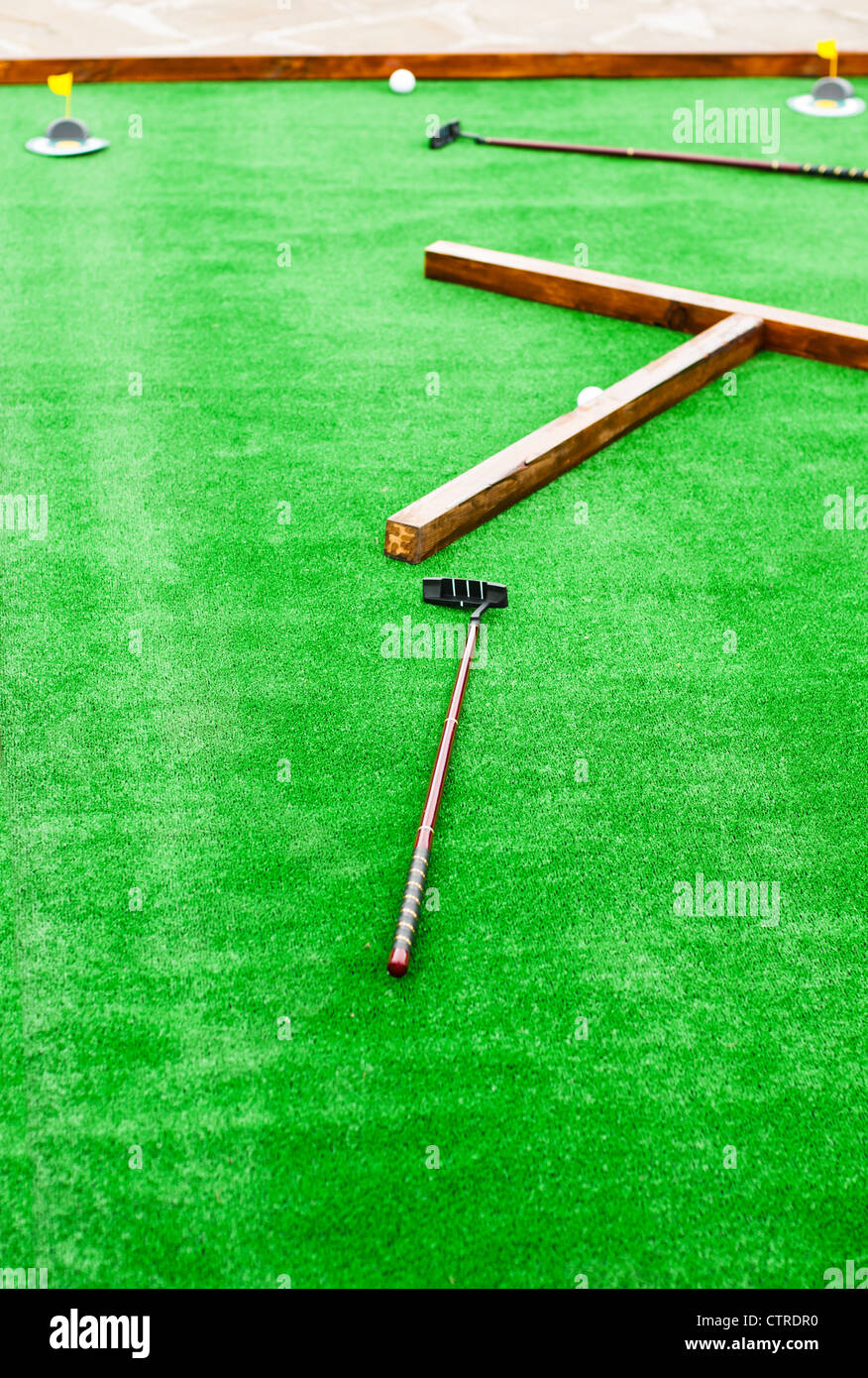 Mini golf field with ball and golf club Stock Photo - Alamy